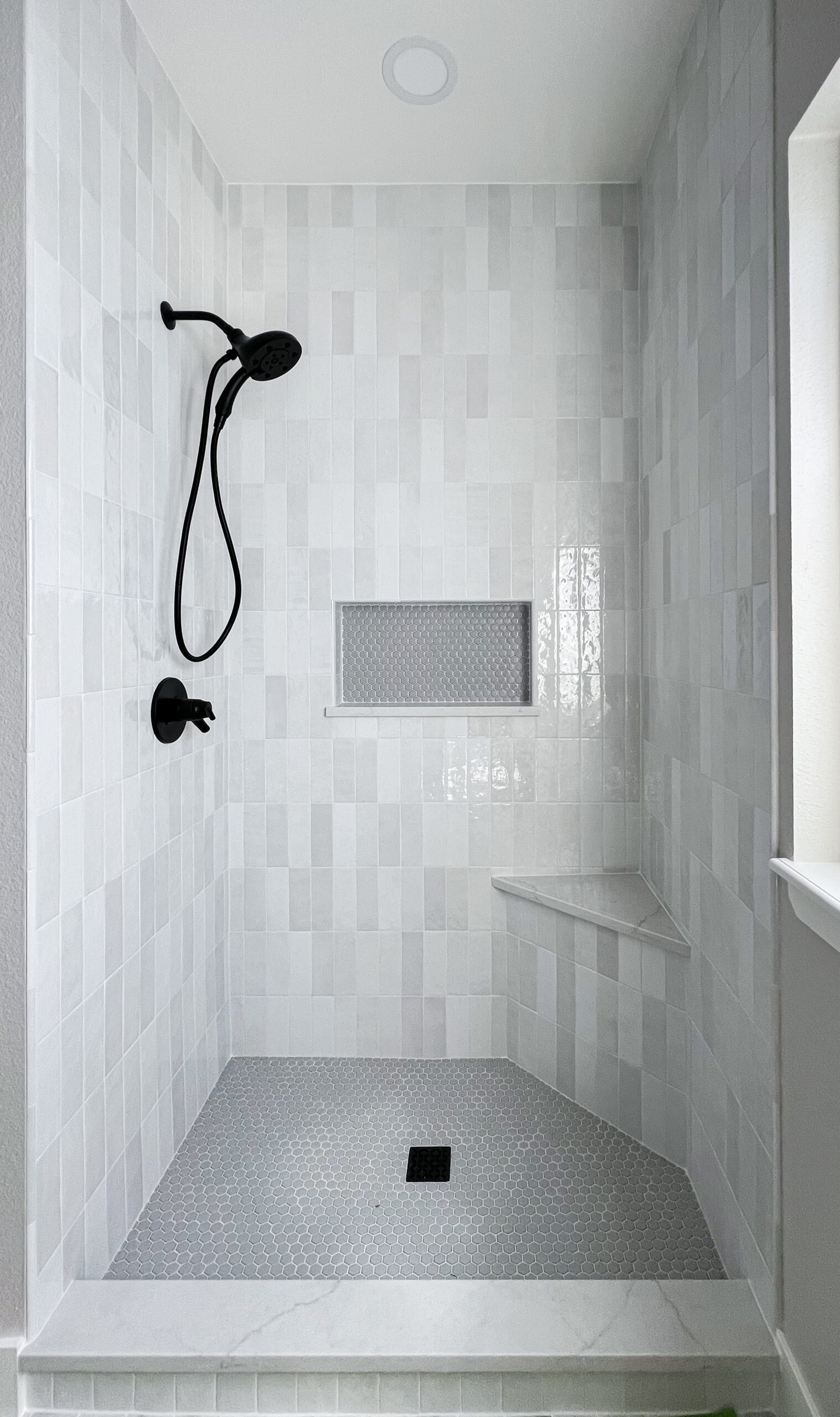 Subway tile in the shower surround in vertical straight pattern up to ...